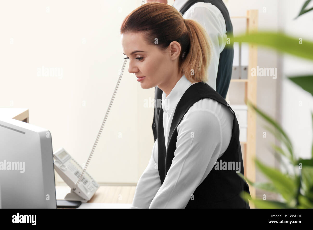 Female receptionist working in hotel Stock Photo - Alamy