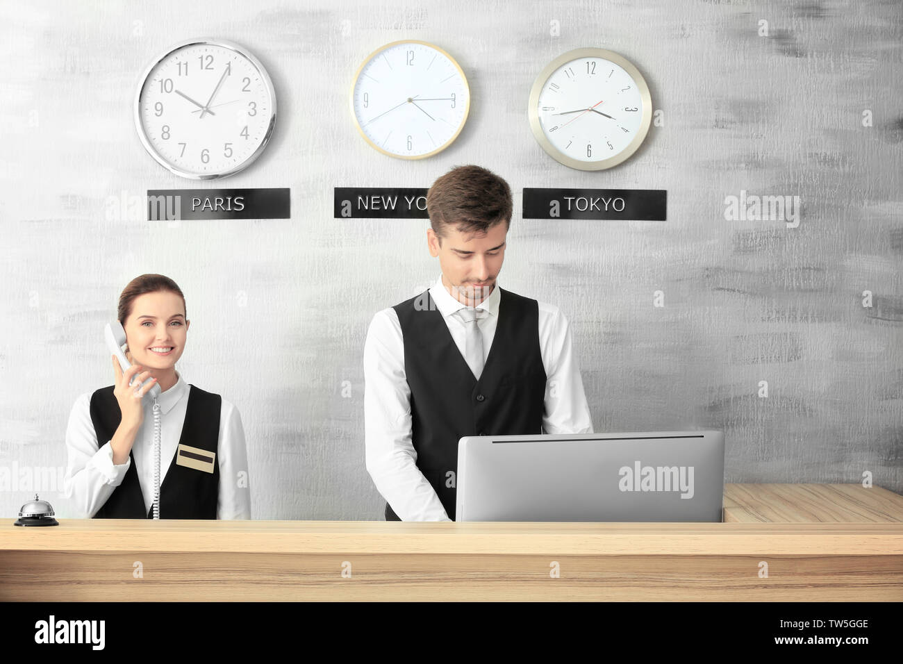 Female and male receptionists working in hotel Stock Photo - Alamy