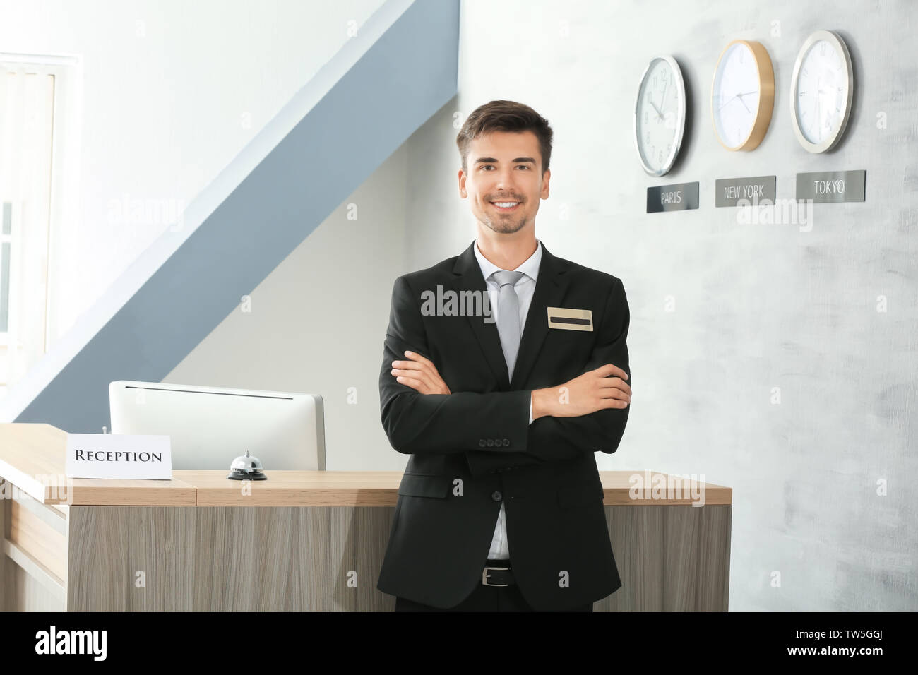 Male receptionist working in hotel Stock Photo - Alamy
