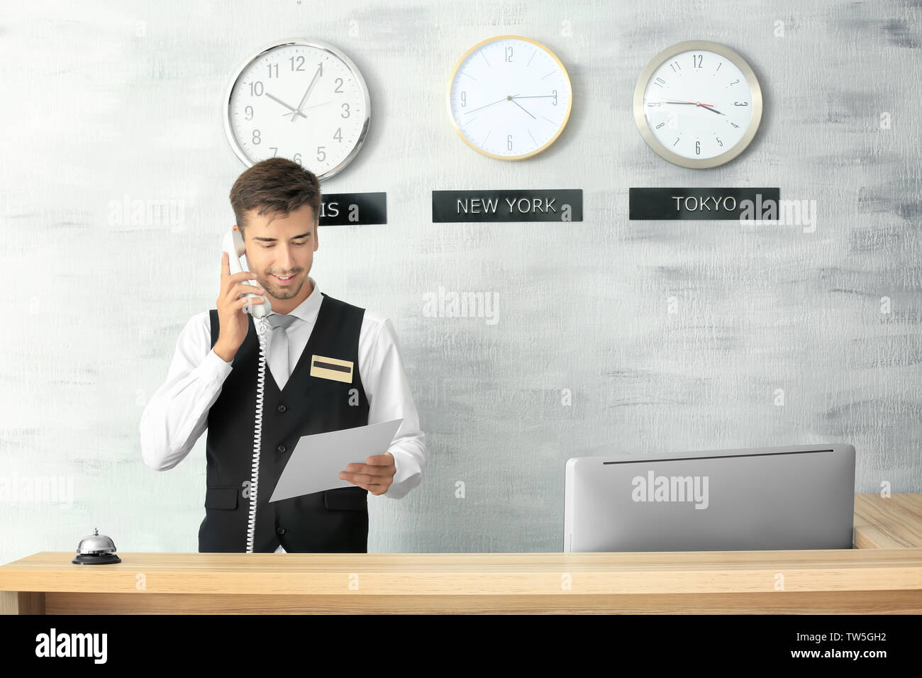 Hotel receptionist phone male hi-res stock photography and images - Alamy