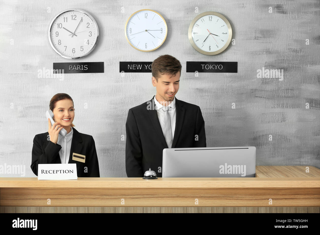 Female and male receptionists working in hotel Stock Photo - Alamy