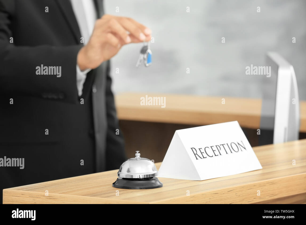 Reception sign with service bell and hotel receptionist on background ...