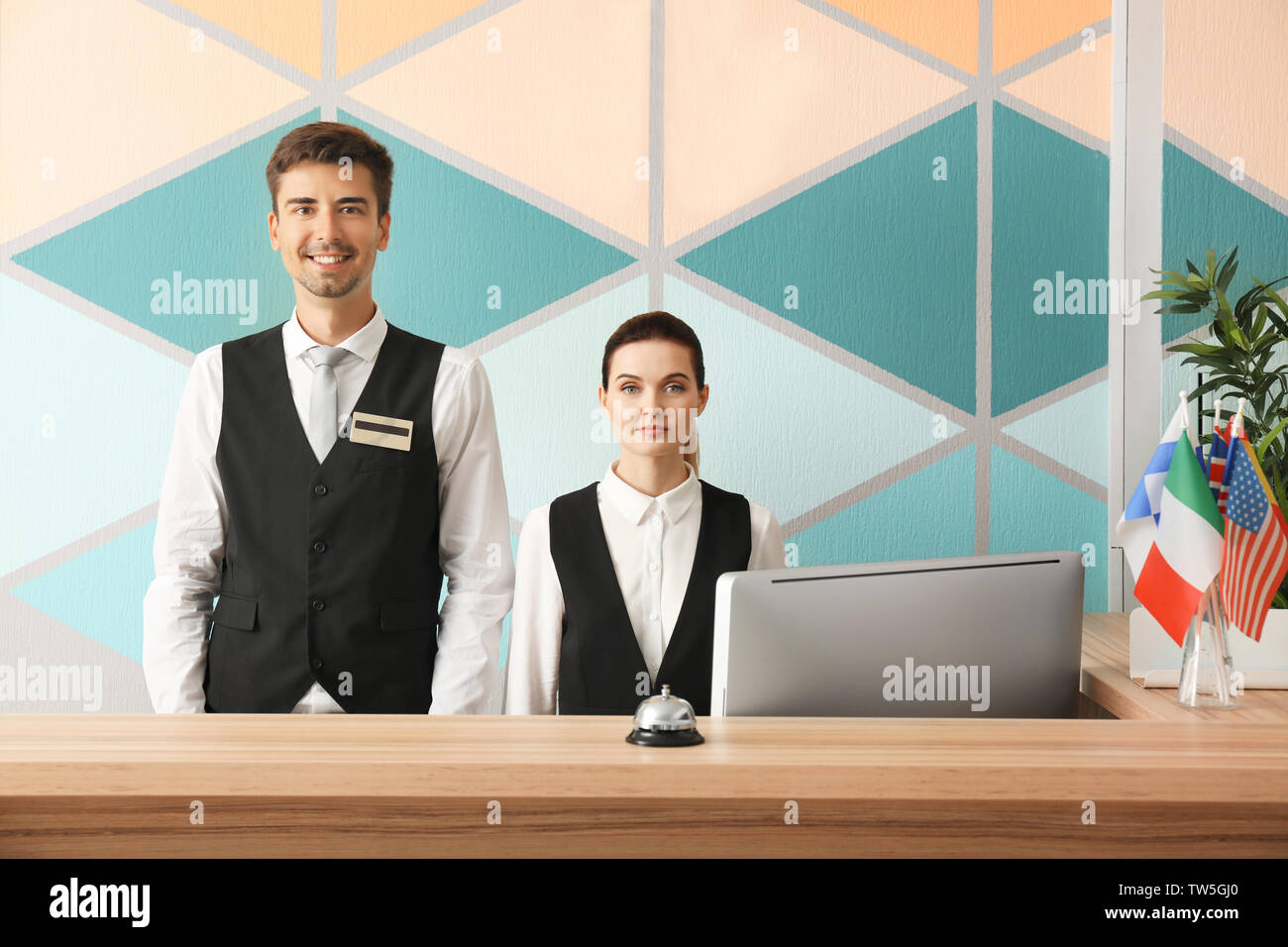 Female and male receptionists working in hotel Stock Photo - Alamy