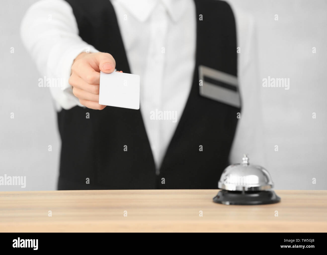 Female receptionist with key card from apartment in hotel Stock Photo ...