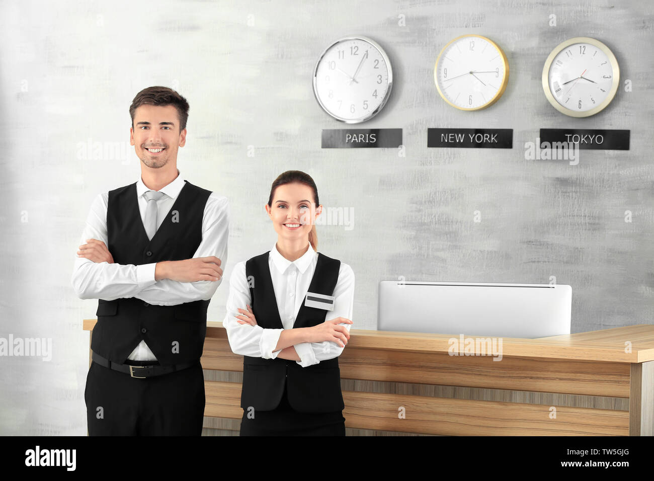 Female and male receptionists working in hotel Stock Photo - Alamy