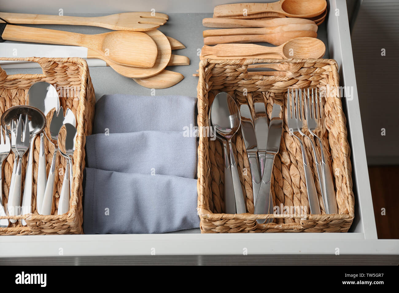 Set of cutlery and wooden utensils in opened kitchen drawer Stock Photo ...