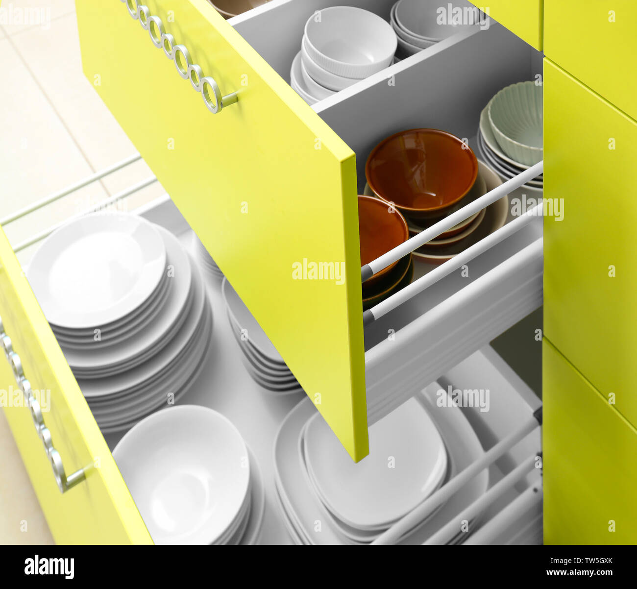 Set of tableware in kitchen drawers Stock Photo - Alamy