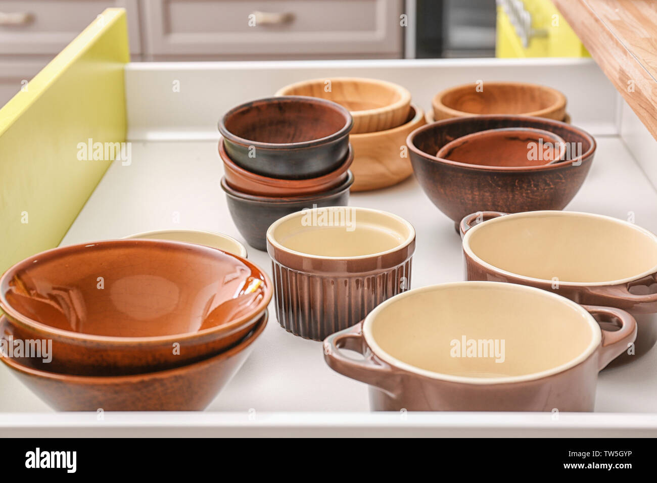Set of tableware in kitchen drawer Stock Photo - Alamy