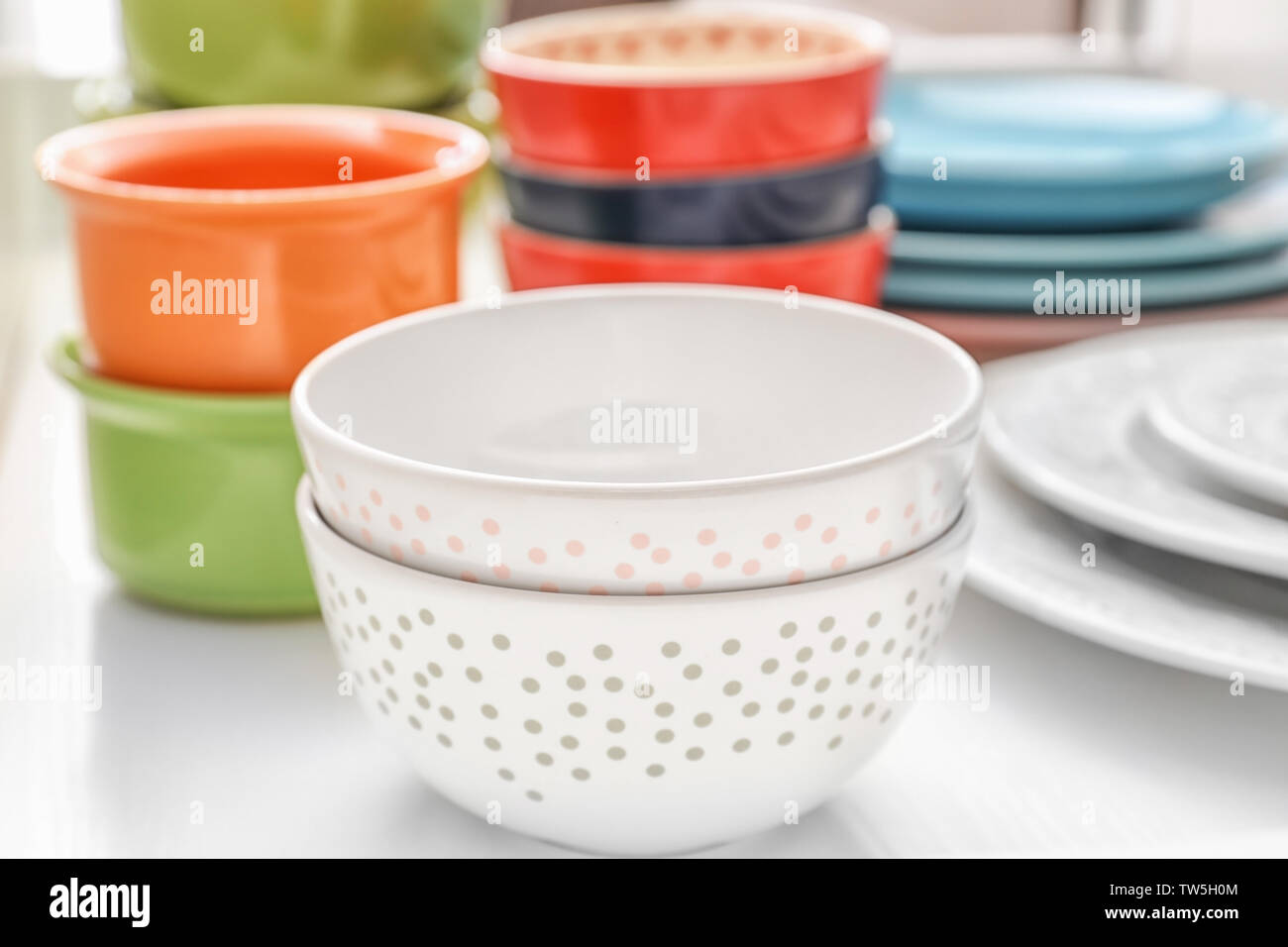 Composition with bowls and tableware on white background Stock Photo ...