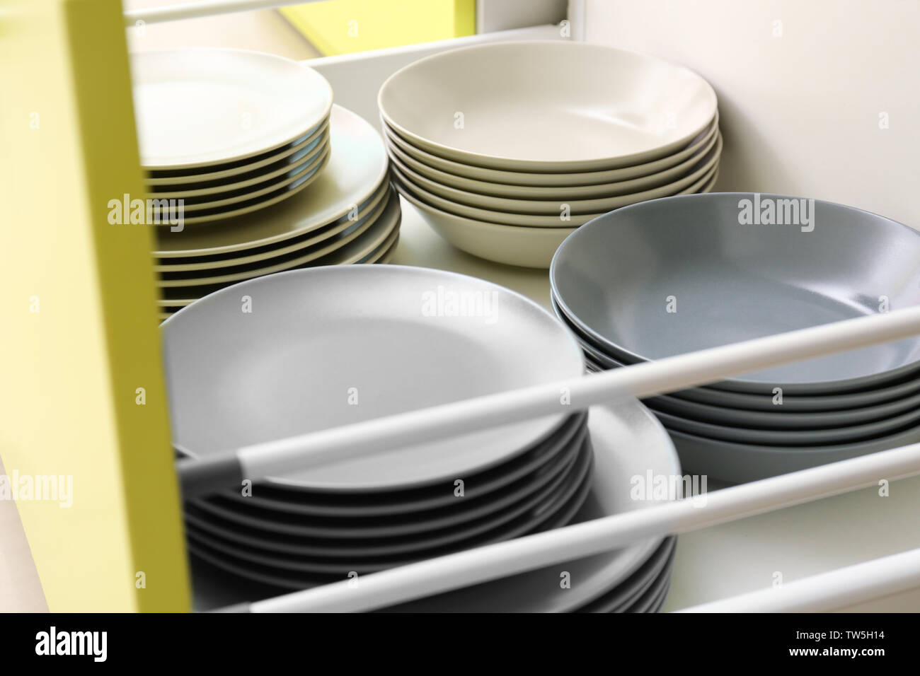 Plates in kitchen drawer Stock Photo - Alamy