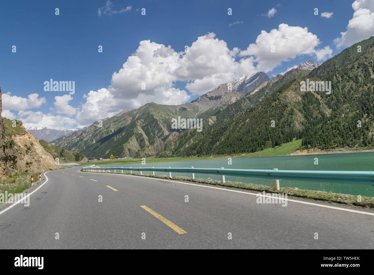 G217 Duku Highway in Alpine Forest under Summer Blue Sky and White ...