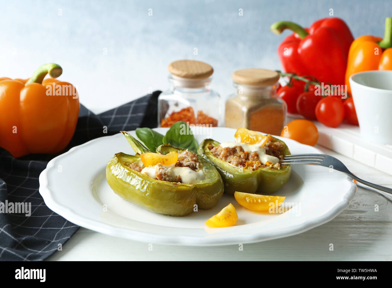 Plate with quinoa stuffed peppers on dinner table Stock Photo - Alamy