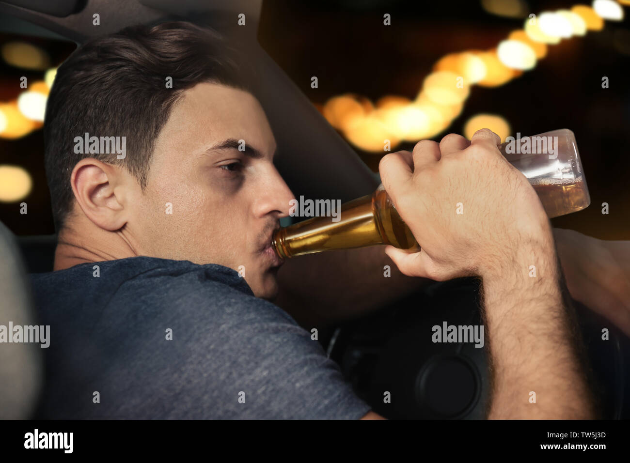 Man drinking alcohol in car Stock Photo - Alamy