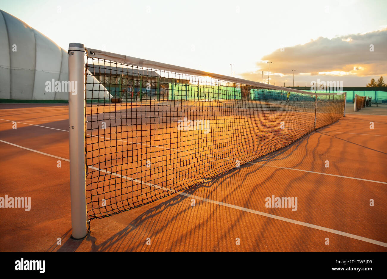 Beautiful tennis court at sunset Stock Photo - Alamy