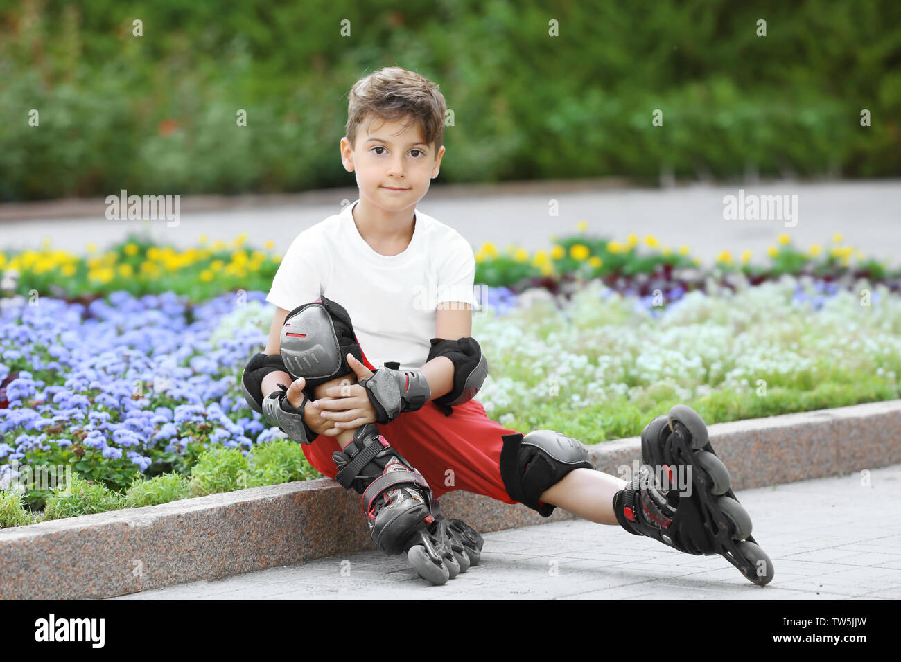 Cute boy on roller skates in park Stock Photo - Alamy