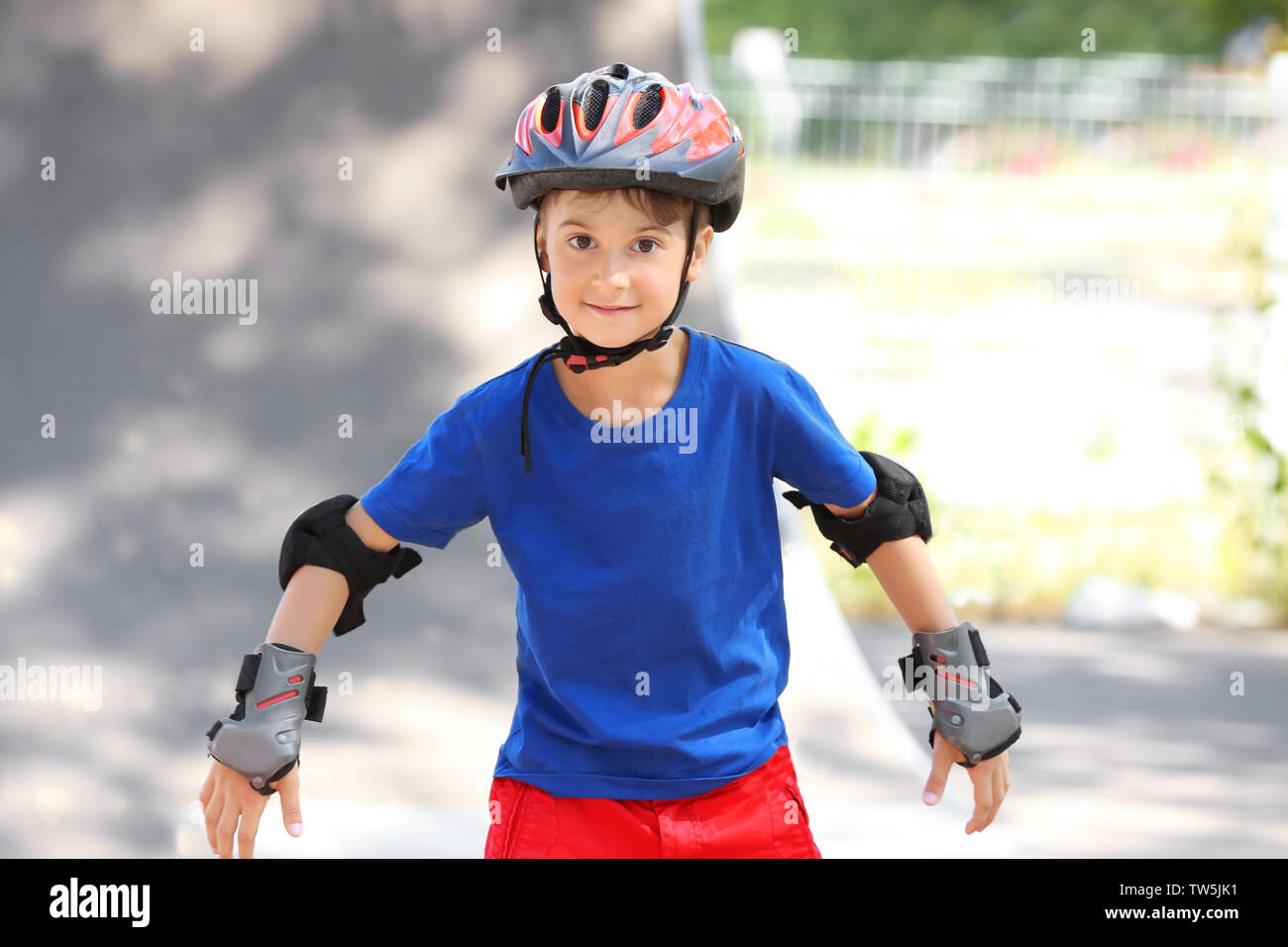 Cute boy rollerblading in skate park Stock Photo - Alamy