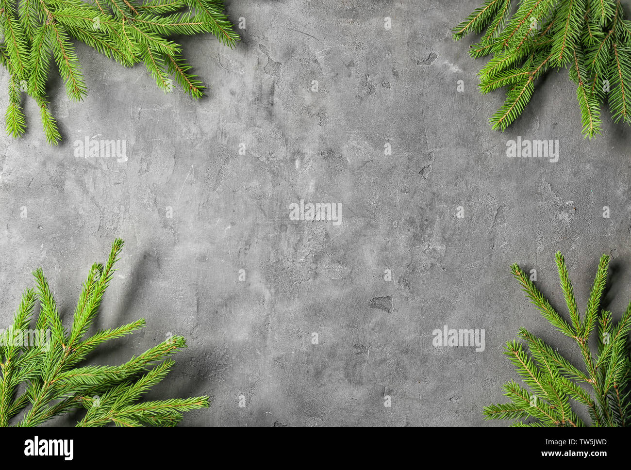 Christmas frame from fir branches on grey background Stock Photo - Alamy