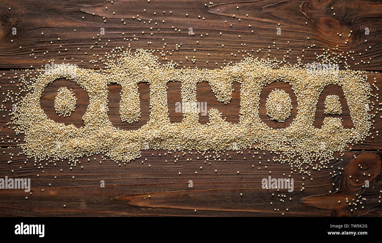 Word made from grains of quinoa on wooden table Stock Photo - Alamy