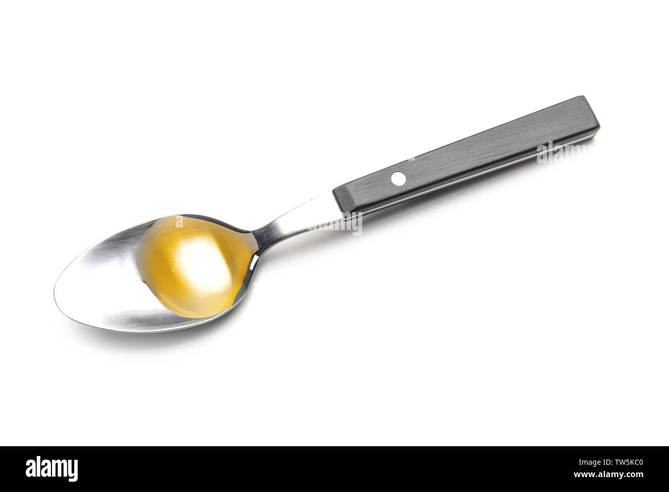 Spoon with cooking oil on white background Stock Photo - Alamy