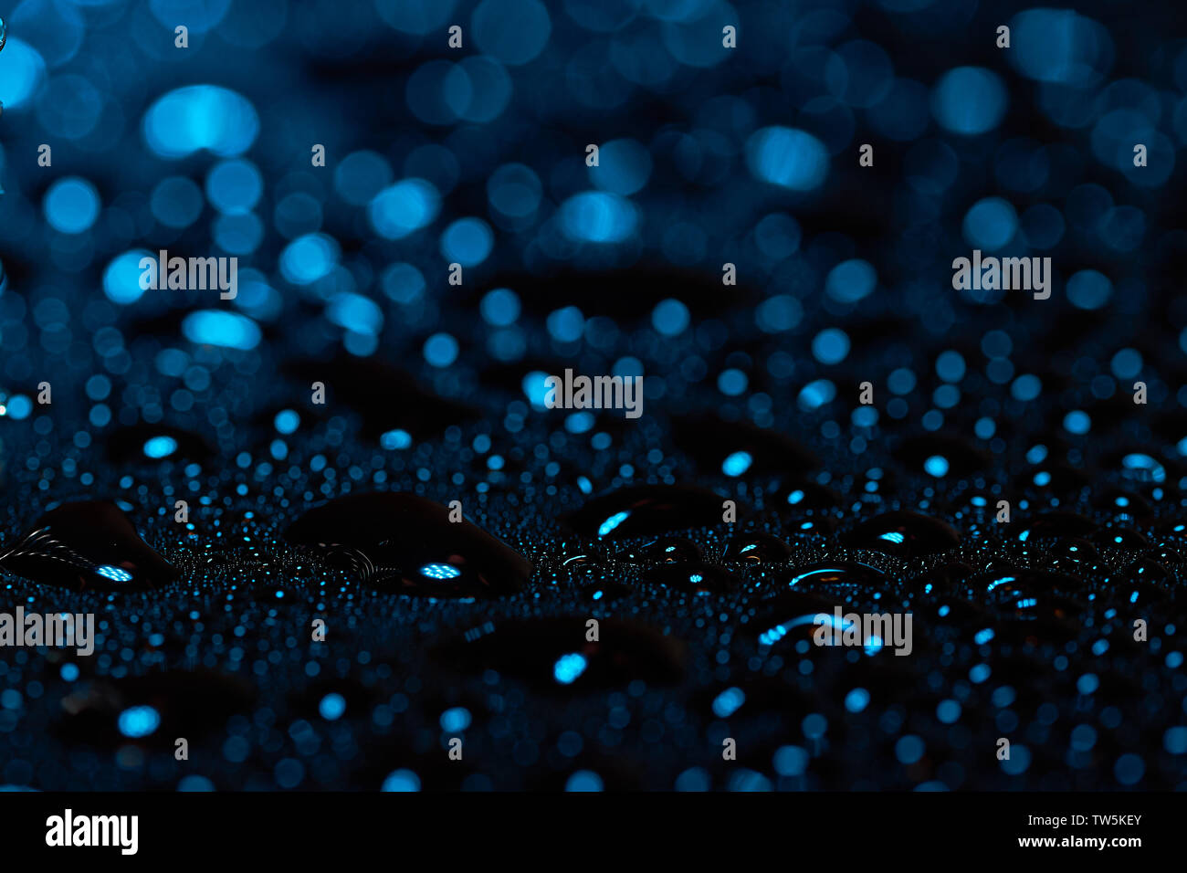 Water drops in a blue light Stock Photo - Alamy