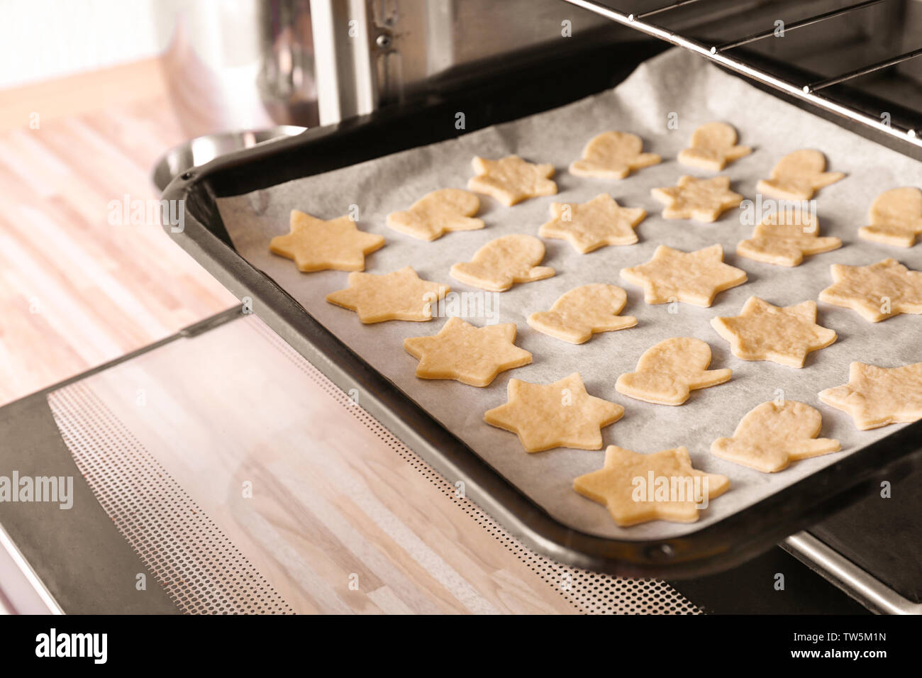 Baking tray with Christmas raw cookies in oven Stock Photo - Alamy