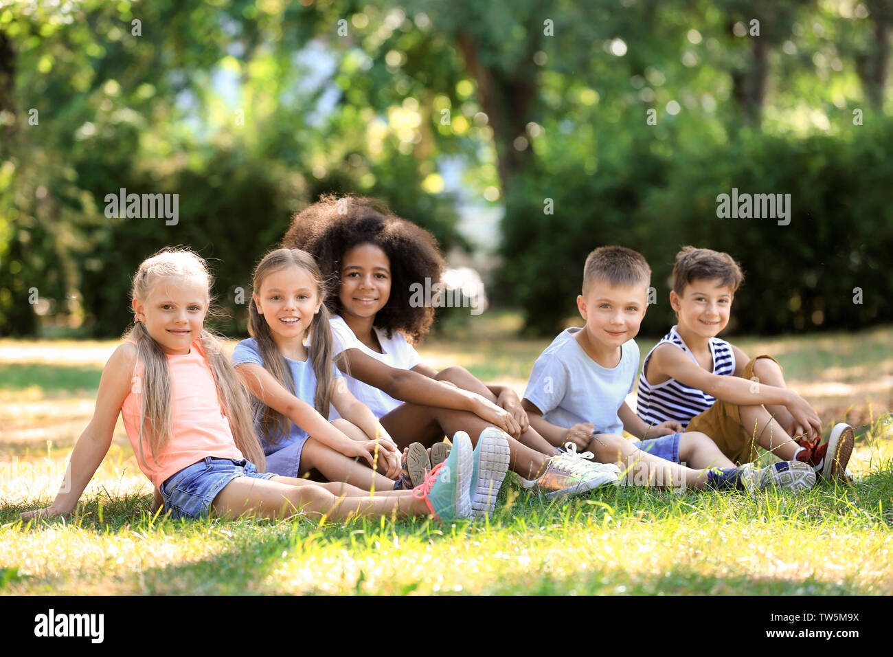Group of boys sitting in grass hi-res stock photography and images - Alamy