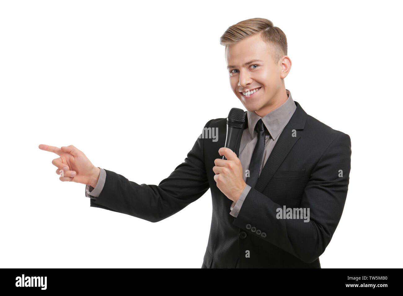 Young presenter with microphone on white background Stock Photo - Alamy