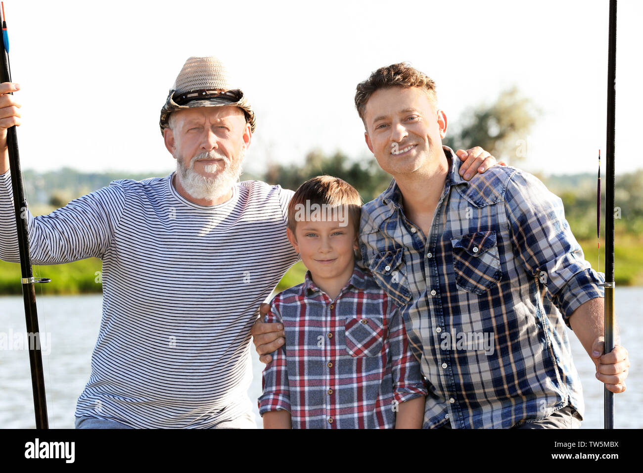 Family fishing on pond together Stock Photo - Alamy