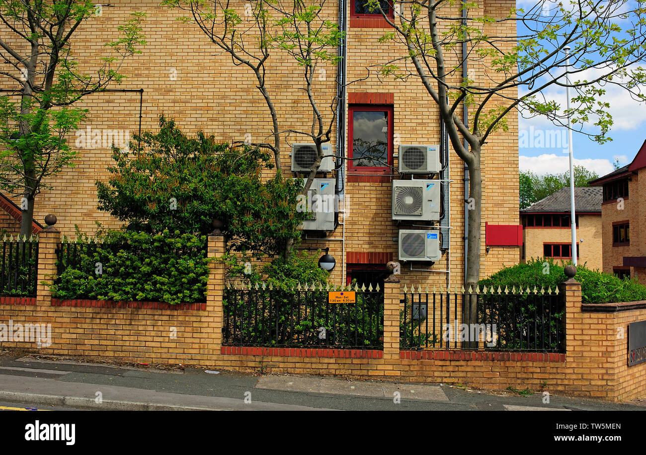 Air conditioner units on the wall of a modern brick built office block ...