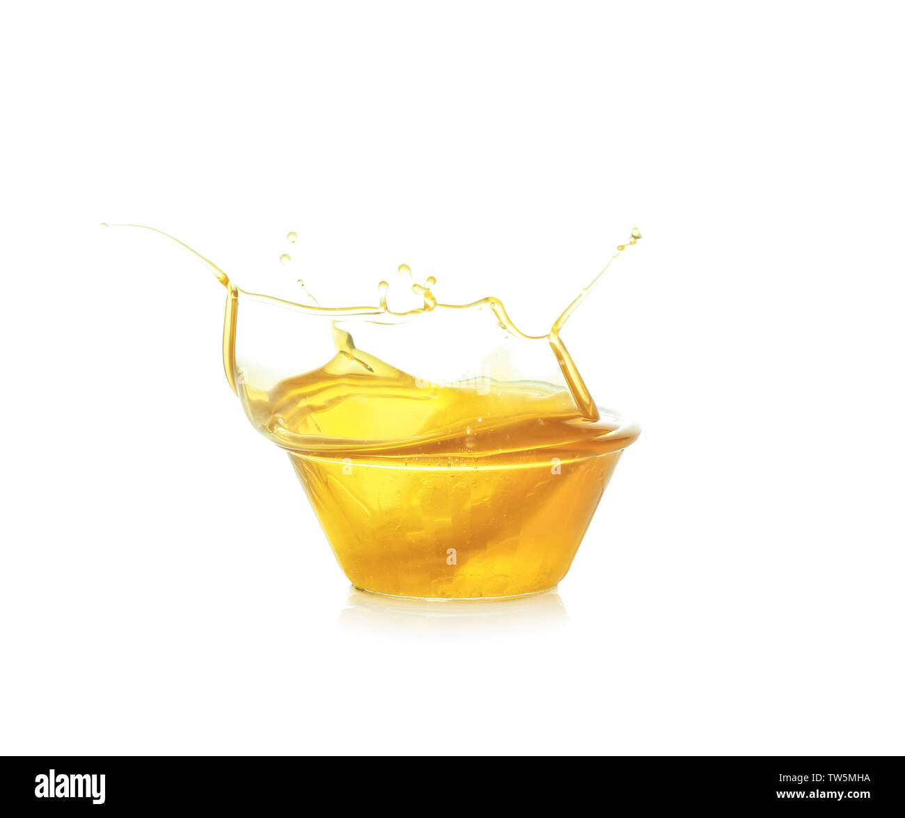Cooking oil splashing from bowl, isolated on white Stock Photo - Alamy