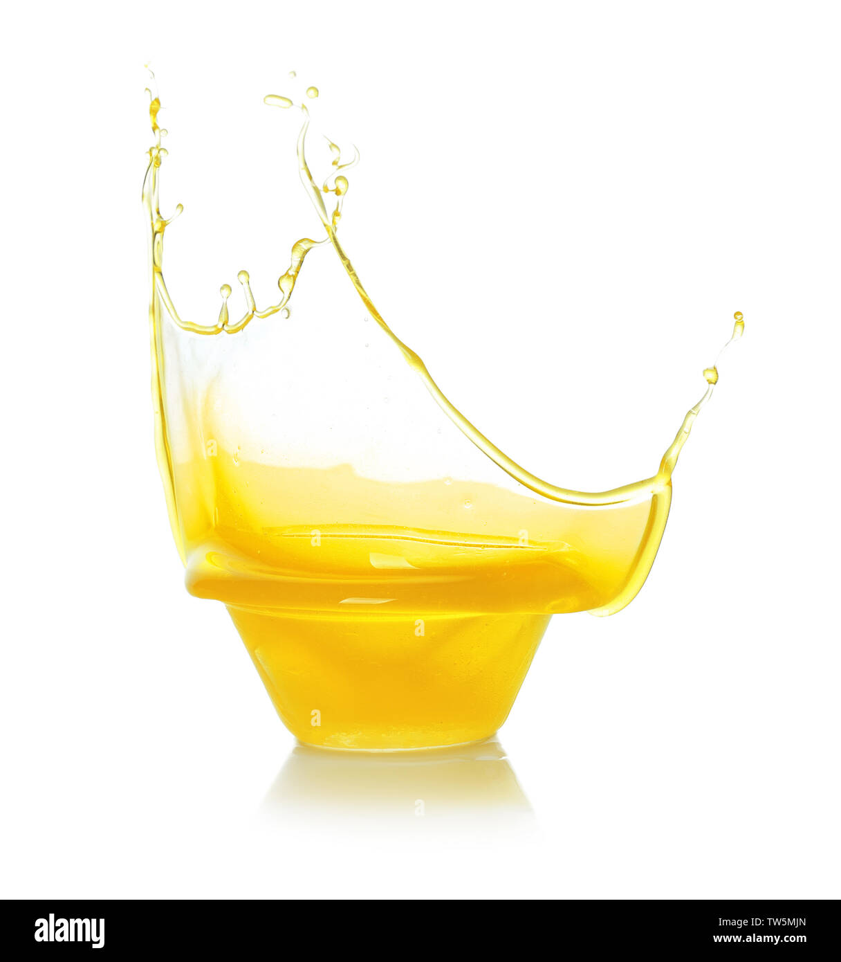 Cooking oil splashing from bowl, isolated on white Stock Photo - Alamy