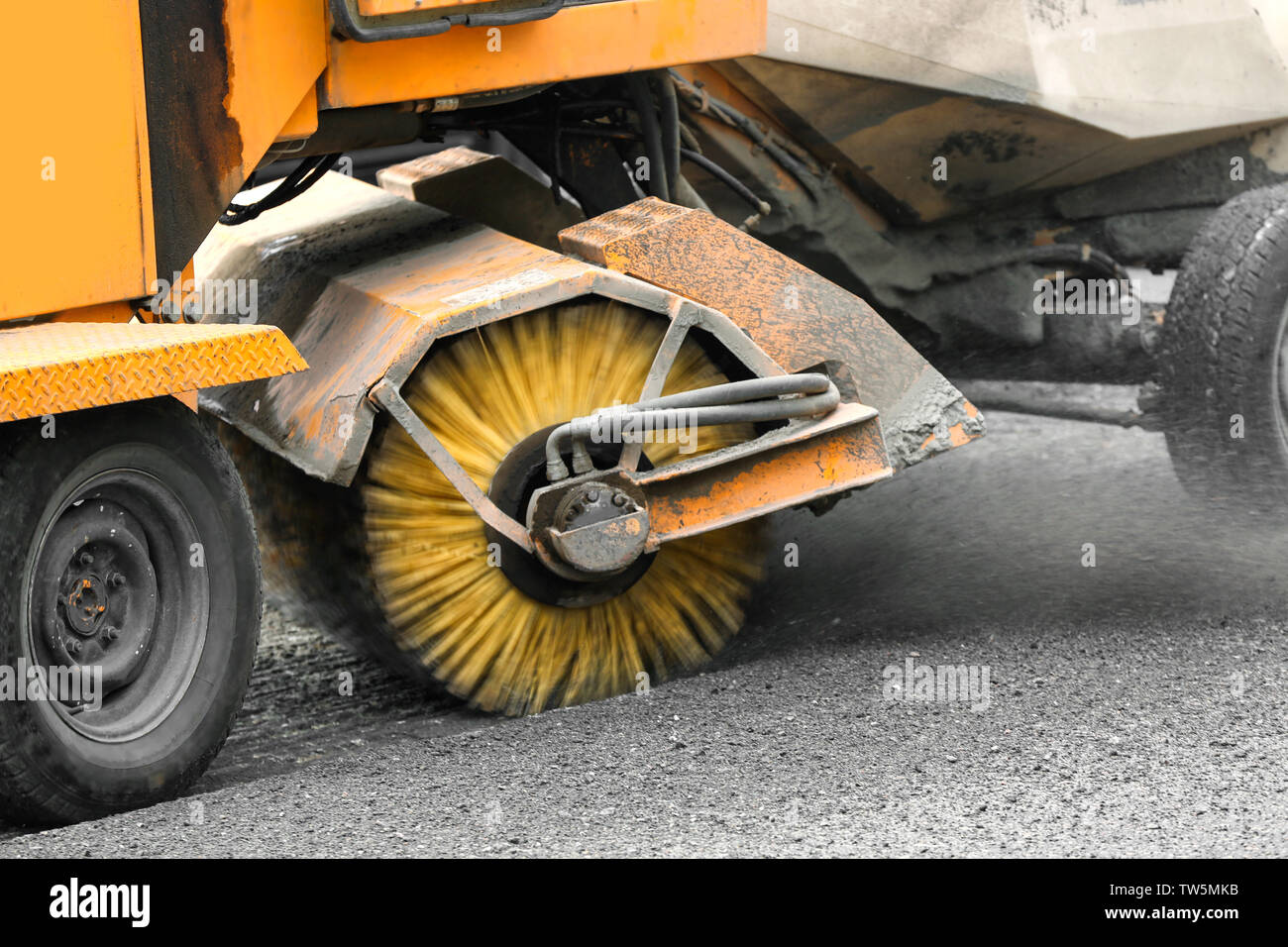 Cleaning machine sweeping road after asphalt removal on city street ...
