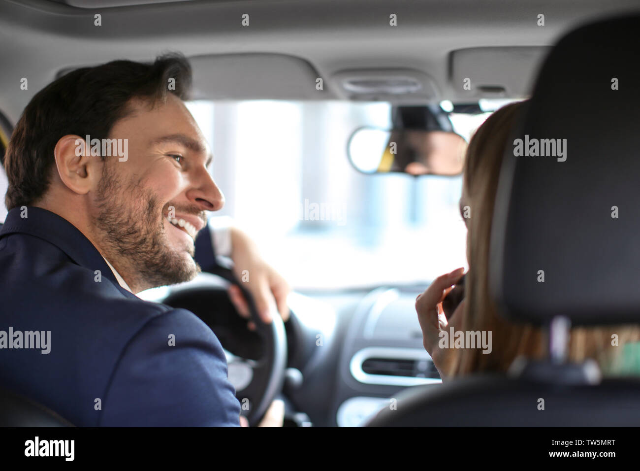 Handsome driver and beautiful female passenger in car Stock Photo - Alamy