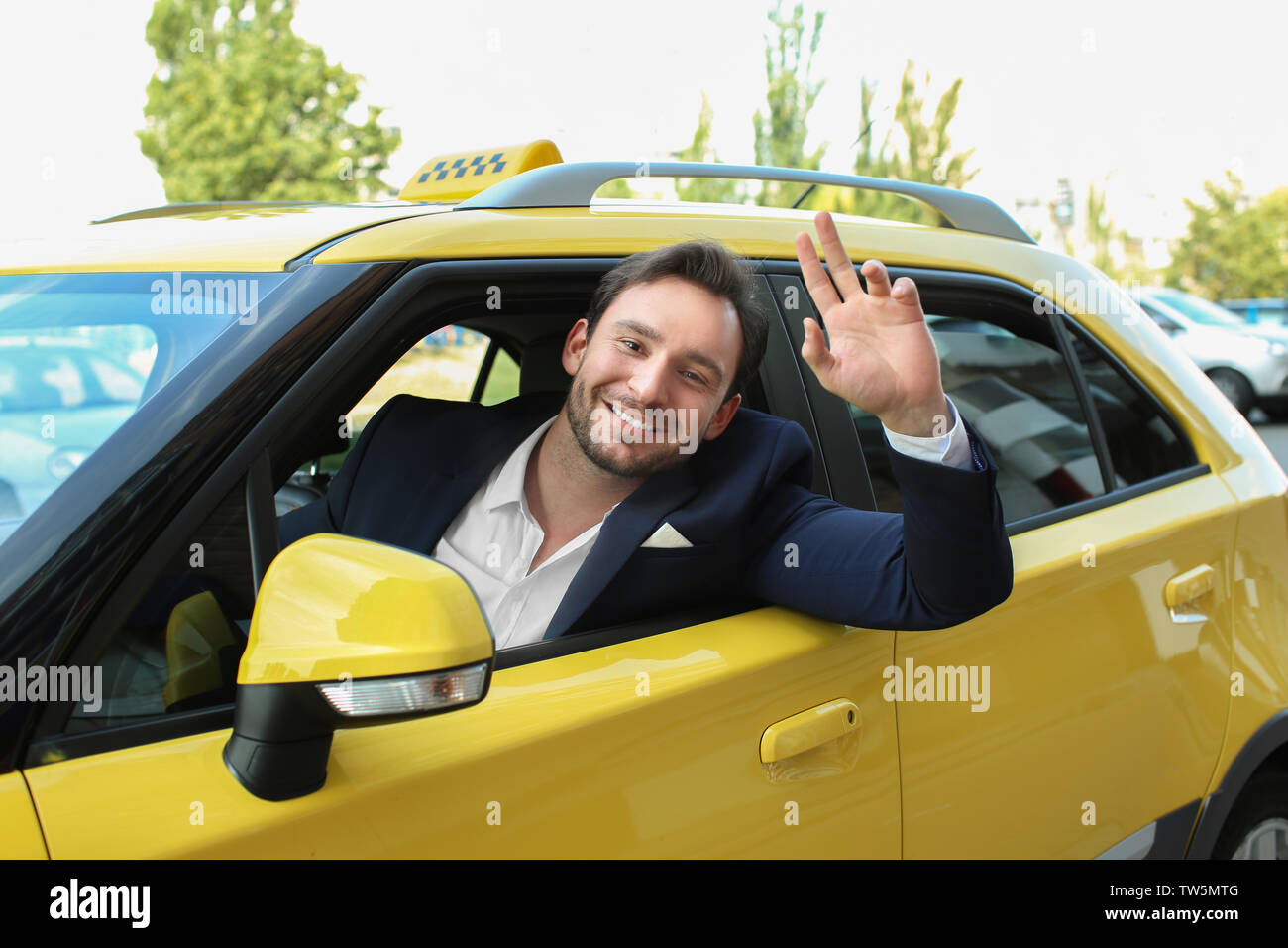 Male taxi driver sitting in yellow car Stock Photo - Alamy