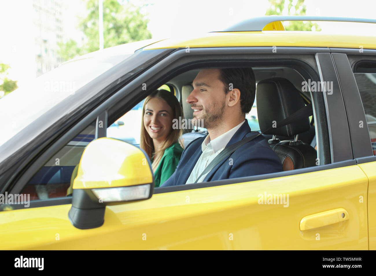 Handsome driver and beautiful female passenger in car Stock Photo - Alamy