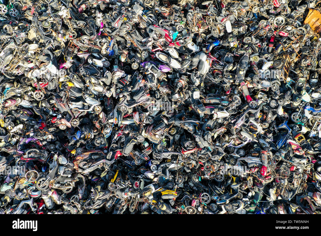 Piled together, scrap-out old motor vehicles waiting to be dismantled ...