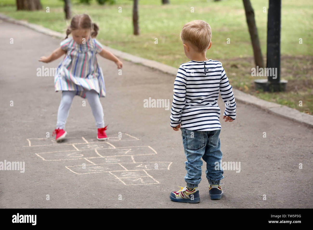 Cute little children playing hopscotch, outdoors Stock Photo - Alamy