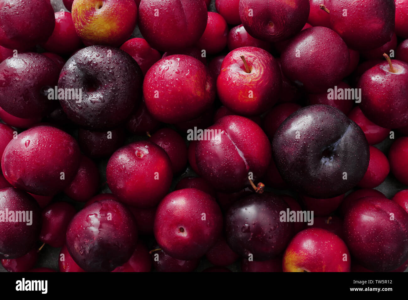 Ripe juicy plums as background Stock Photo - Alamy