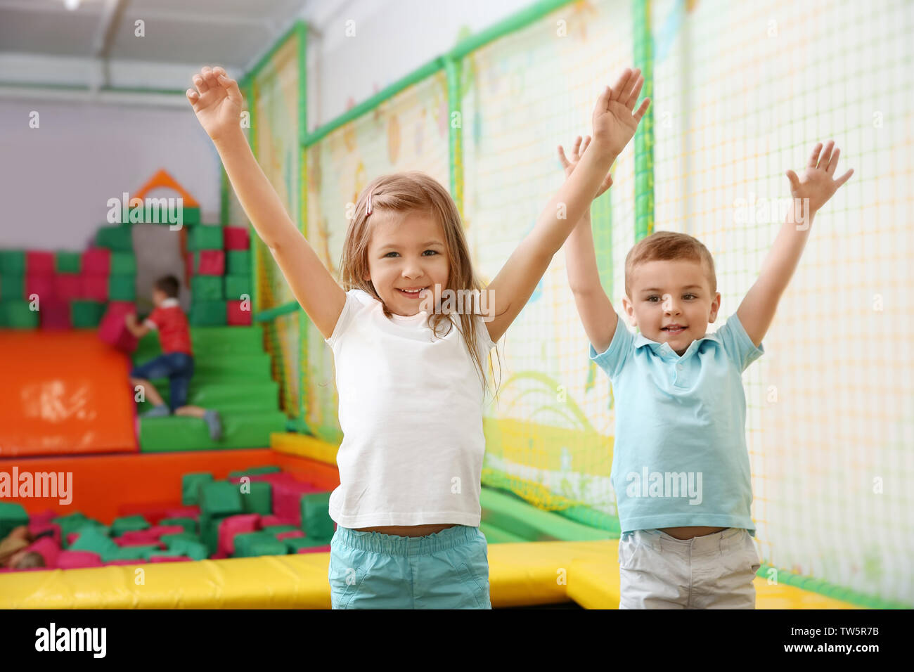 Cute children playing in entertainment center Stock Photo - Alamy