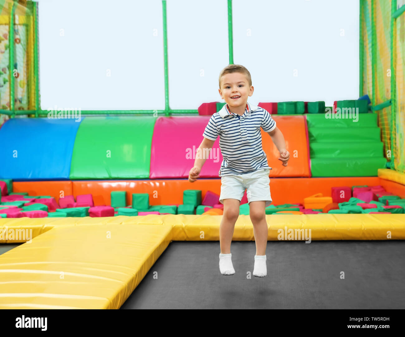 Cute boy jumping on trampoline in entertainment center Stock Photo - Alamy