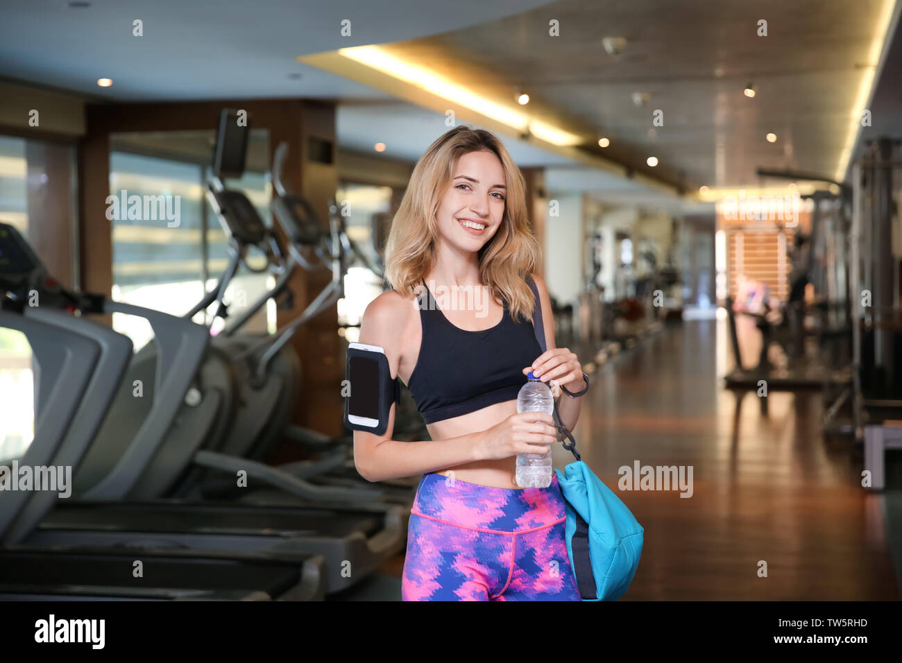 Beautiful young woman in modern gym Stock Photo - Alamy