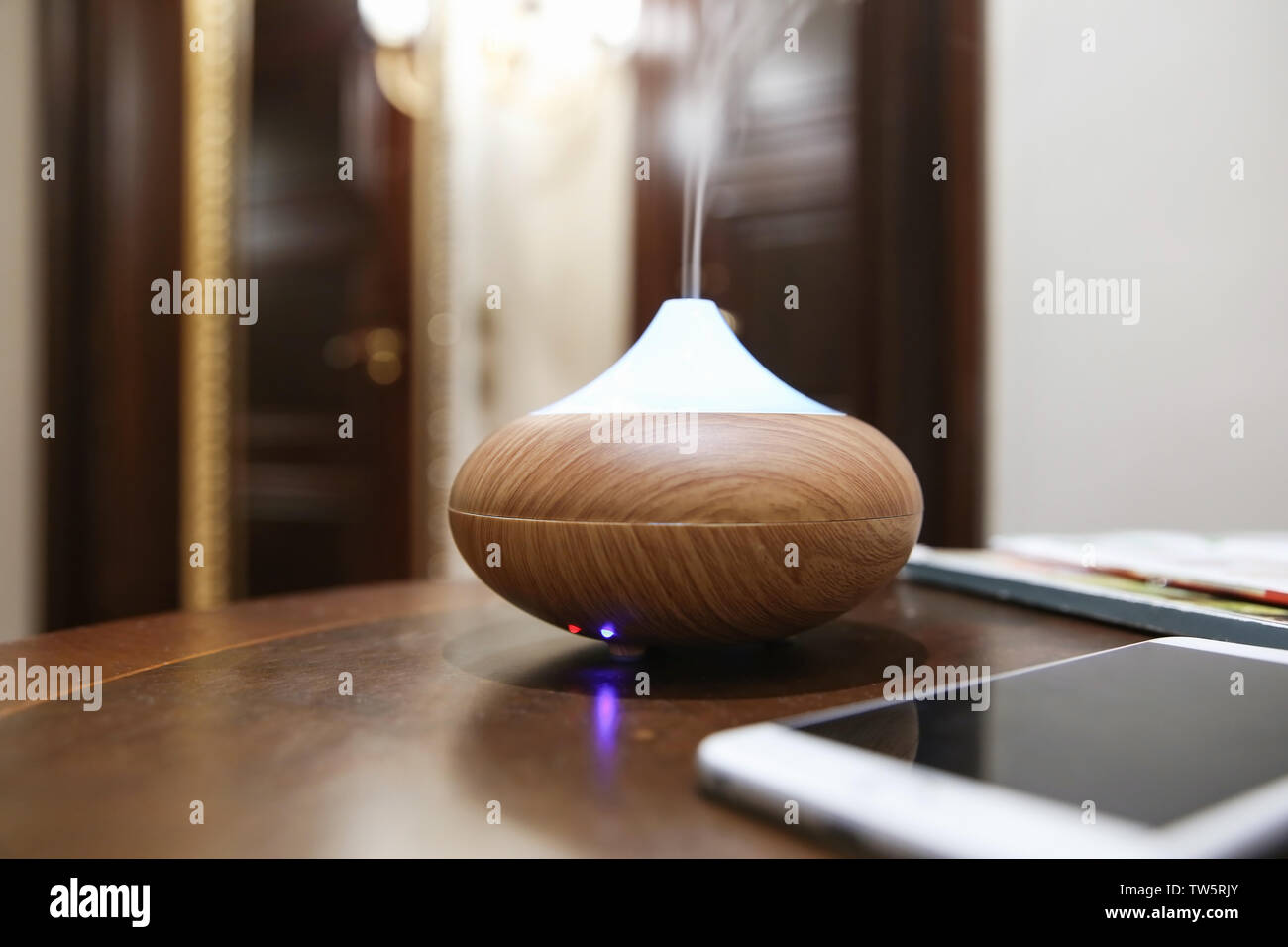 Aroma oil diffuser on table im room Stock Photo - Alamy