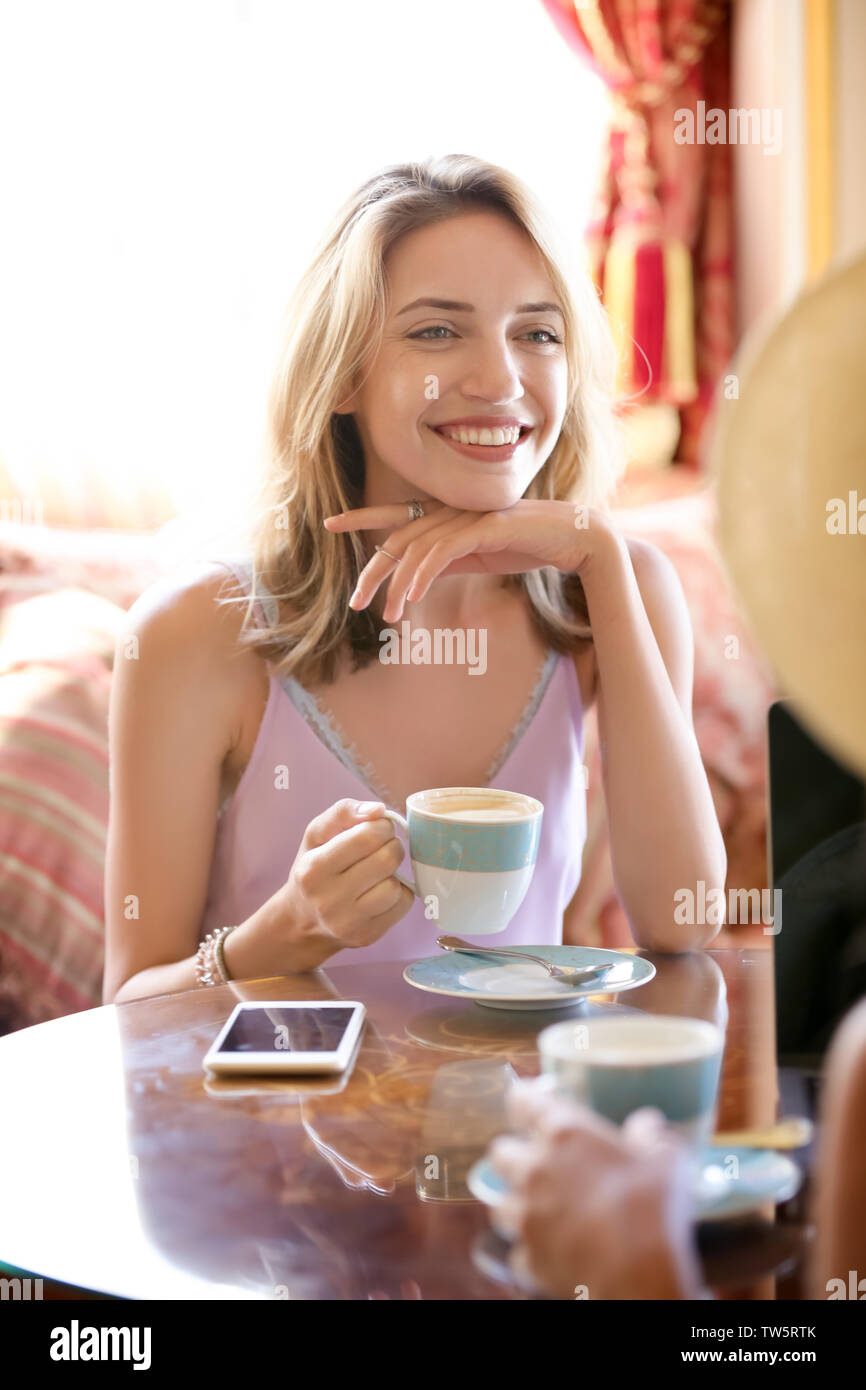 Beautiful young women drinking coffee in cafe Stock Photo - Alamy