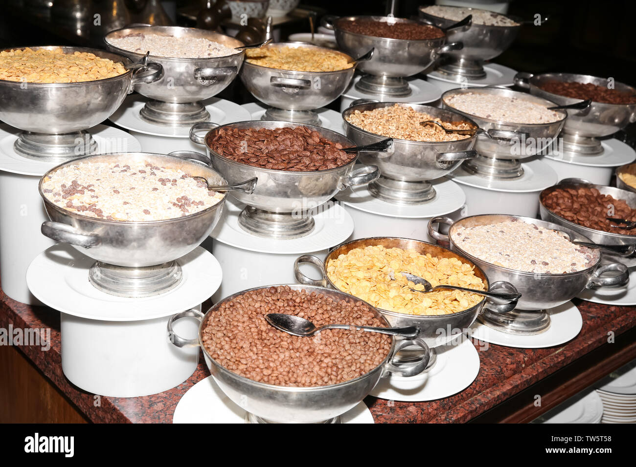 Different kinds of breakfast cereals in bowls on table at buffet Stock ...