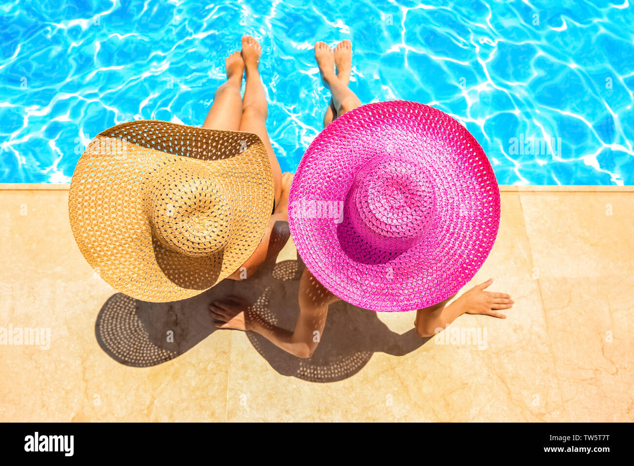 Young women in hats near swimming pool Stock Photo - Alamy