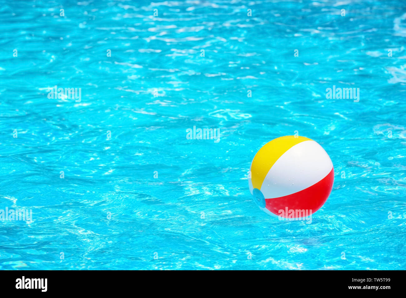 Colorful inflatable ball in blue swimming pool Stock Photo - Alamy