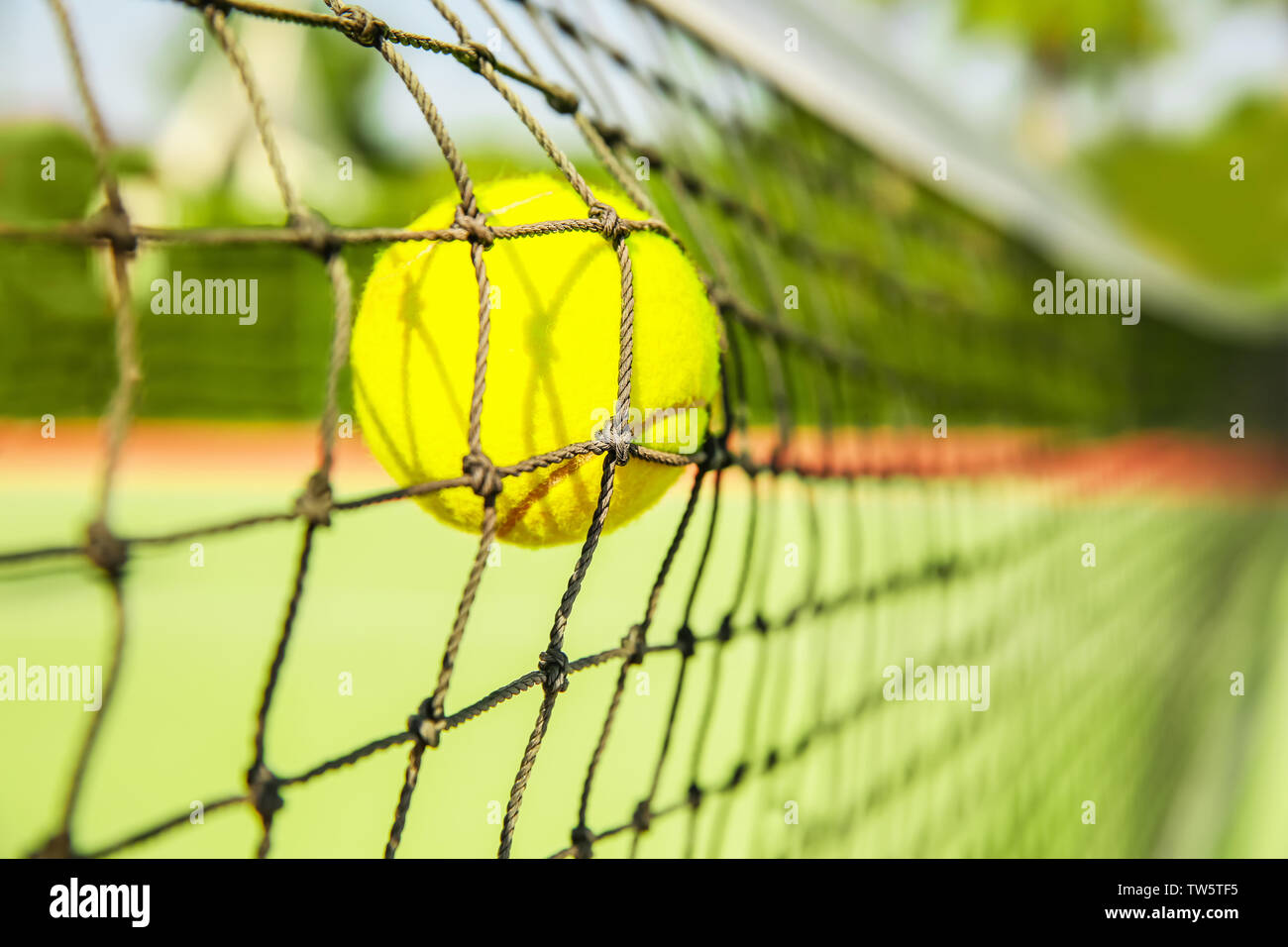 Tennis ball in net, closeup Stock Photo - Alamy