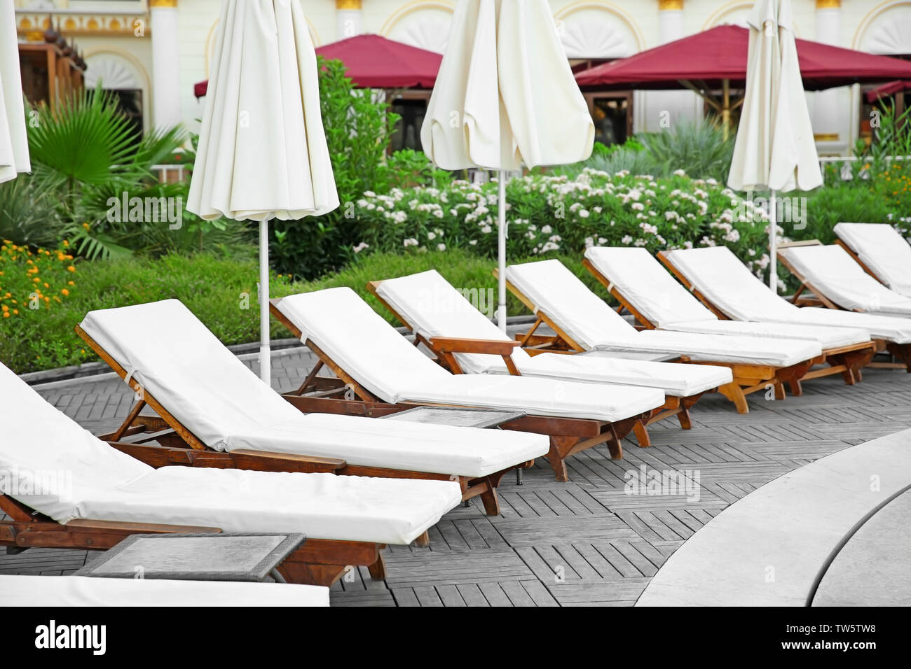 Empty sunbeds at luxury hotel Stock Photo - Alamy