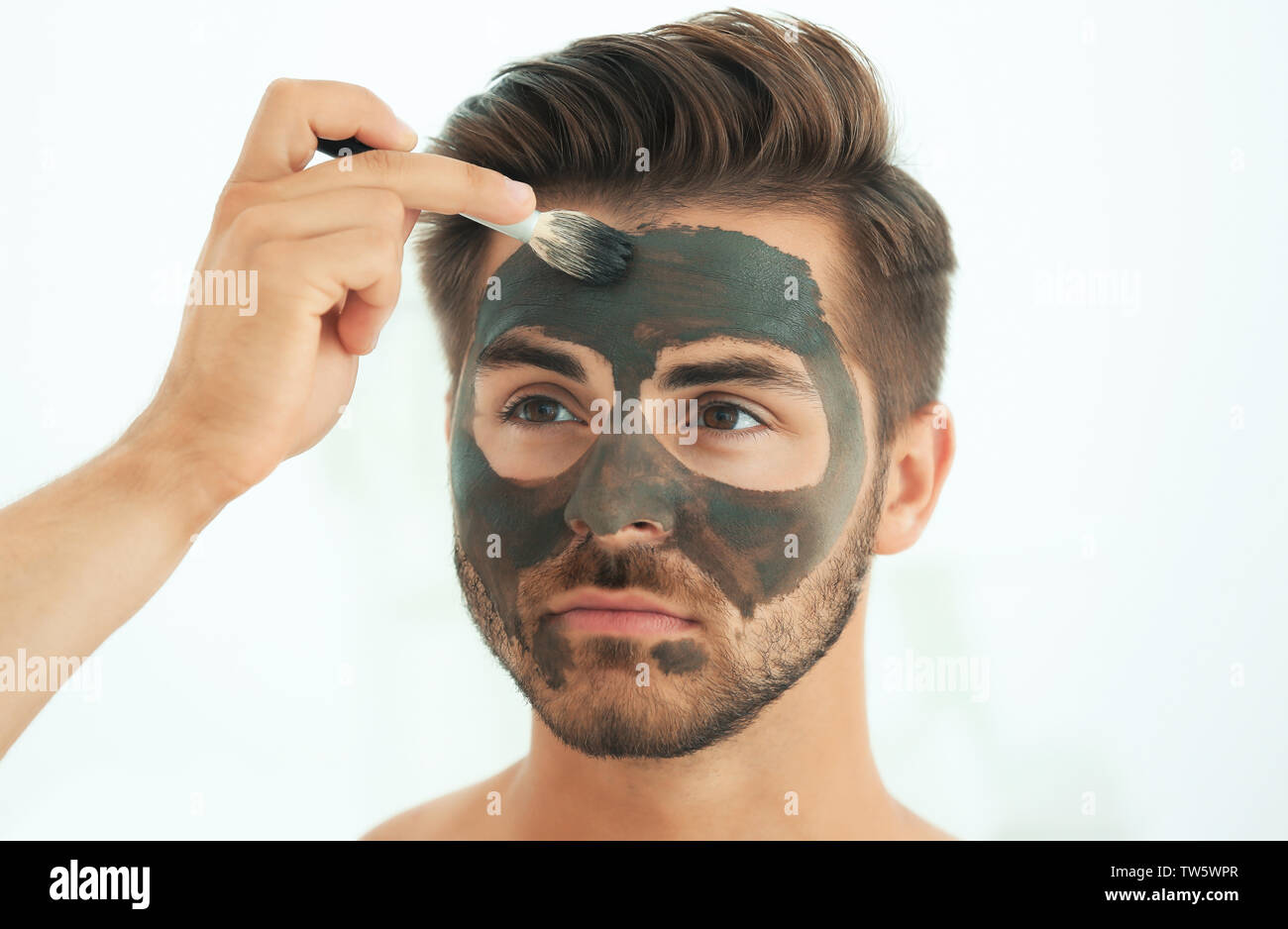 Applying black mask on face hi-res stock photography and images - Alamy