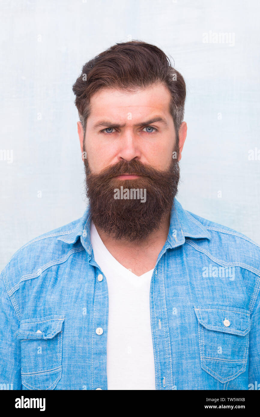 Well groomed macho. Hipster with beard and mustache wear denim shirt ...